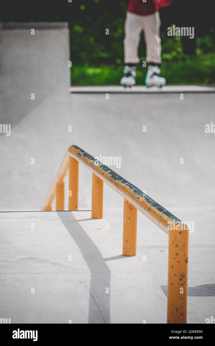 A vertical shot of grind rail at a skatepark in white background ...