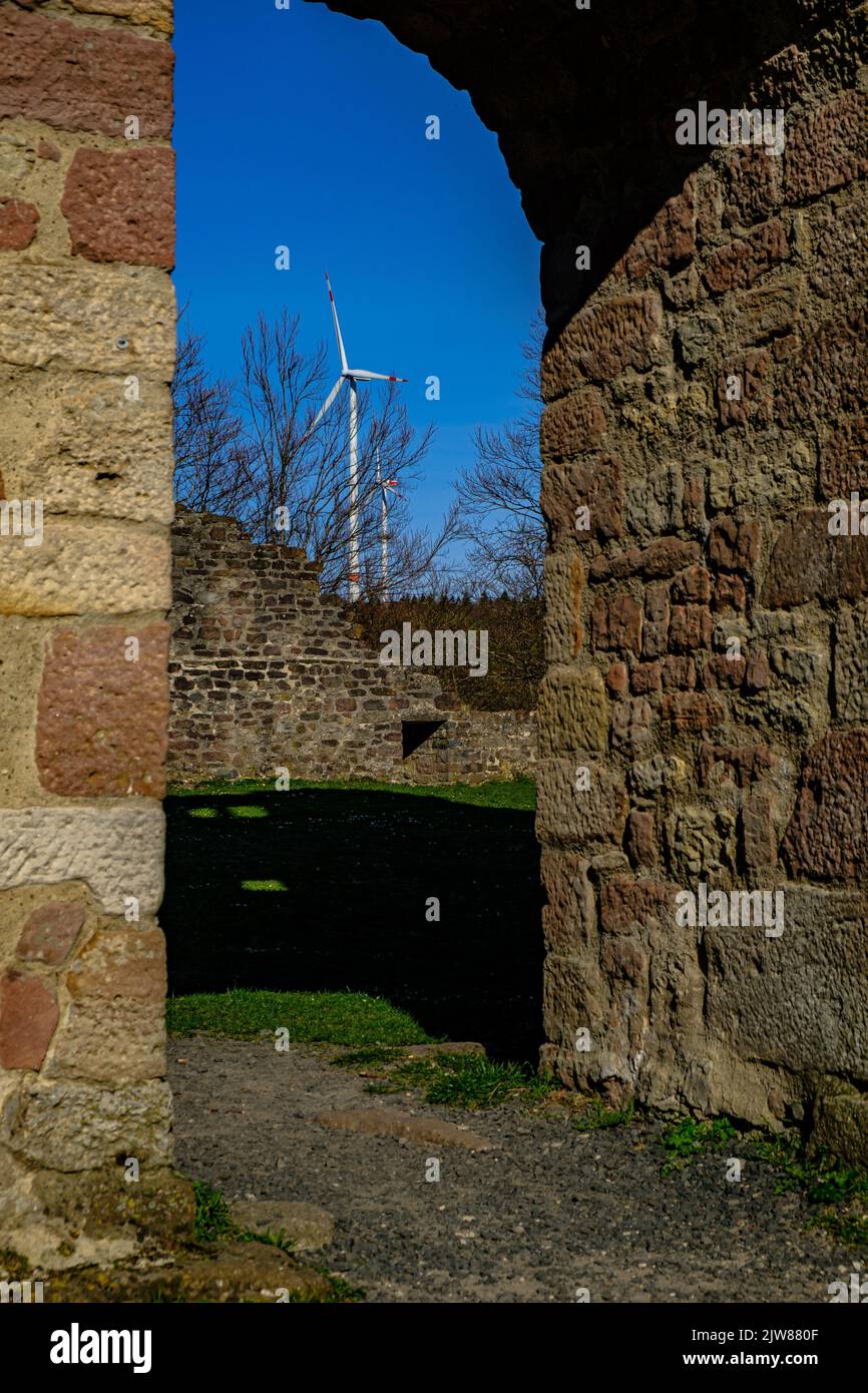 A vertical shot of the ruins of castle Steckelberg with a stone arch at ...