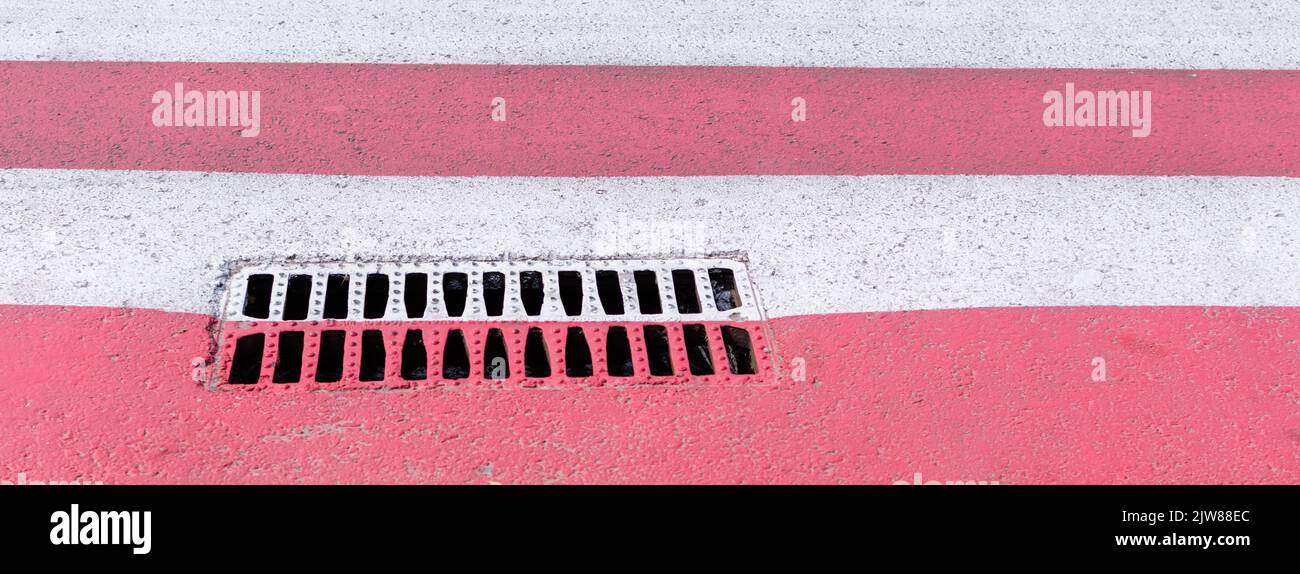 Metal grating for rainwater drainage on asphalt road surface on ...