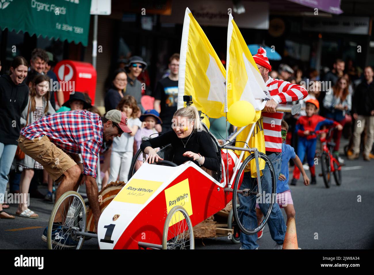 Children and adults take part in races with their bicycles, scooters ...