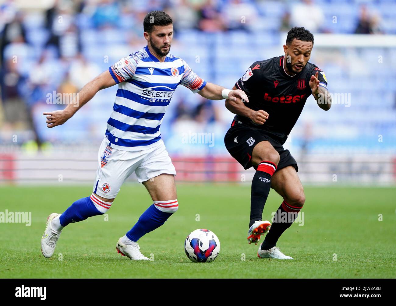 Reading's Shane Long battles with Stoke City's Jacob Brown during the ...