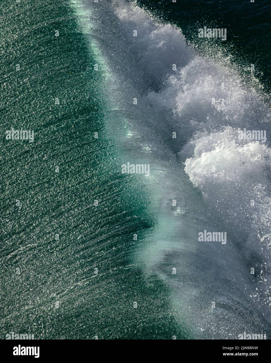 Aerial image of a crashing wave hitting the shore at Kynance Cove ...