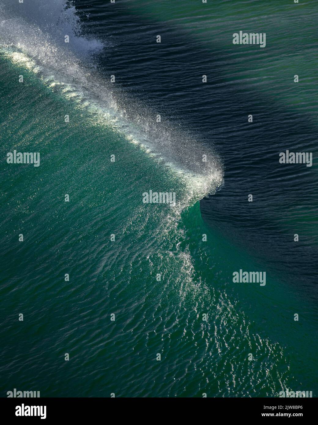 Aerial image of a barrelled wave rolling into the beach at Kynance Cove ...