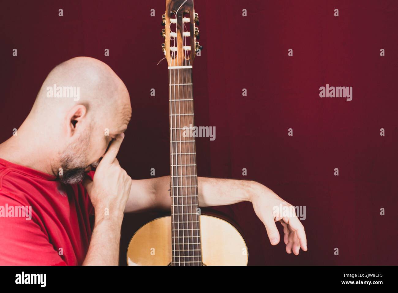 String musical instrument. Mature charismatic male guitarist. guy with ...