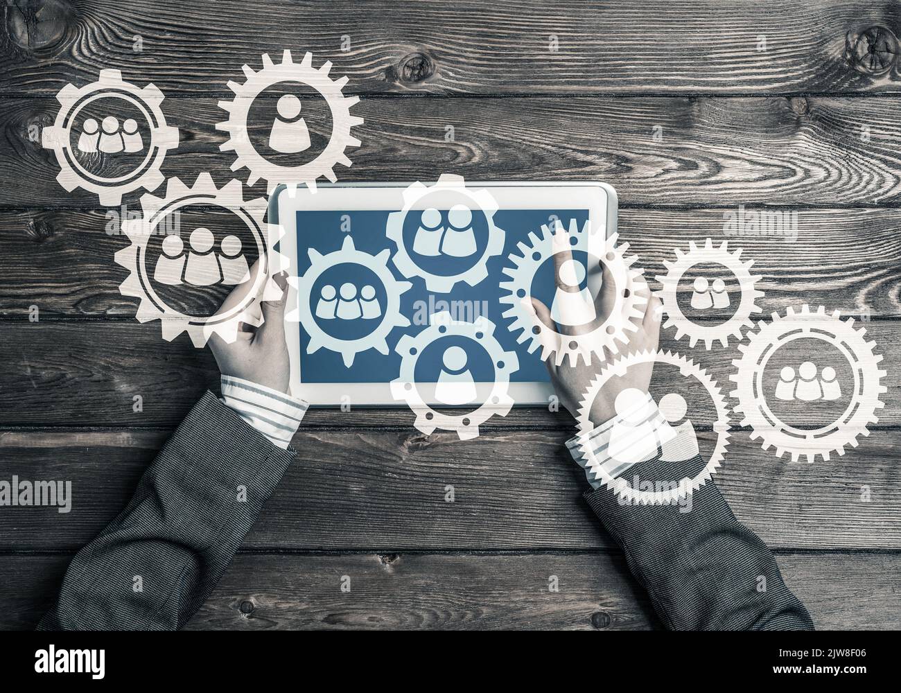 Concept of teamworking and connection with gears mechanism and tablet ...