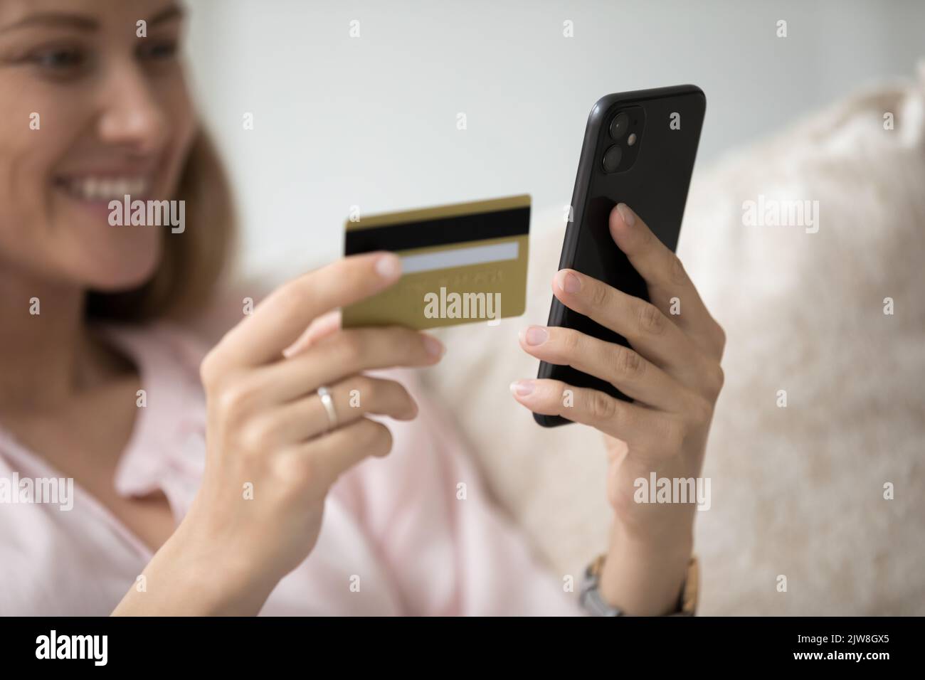 Happy millennial cellphone user woman using credit card Stock Photo - Alamy