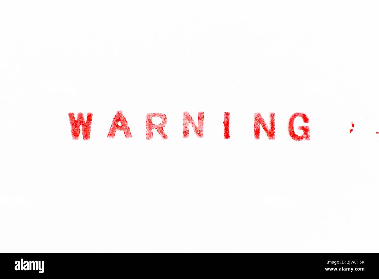 Red color ink rubber stamp in word warning on white paper background ...