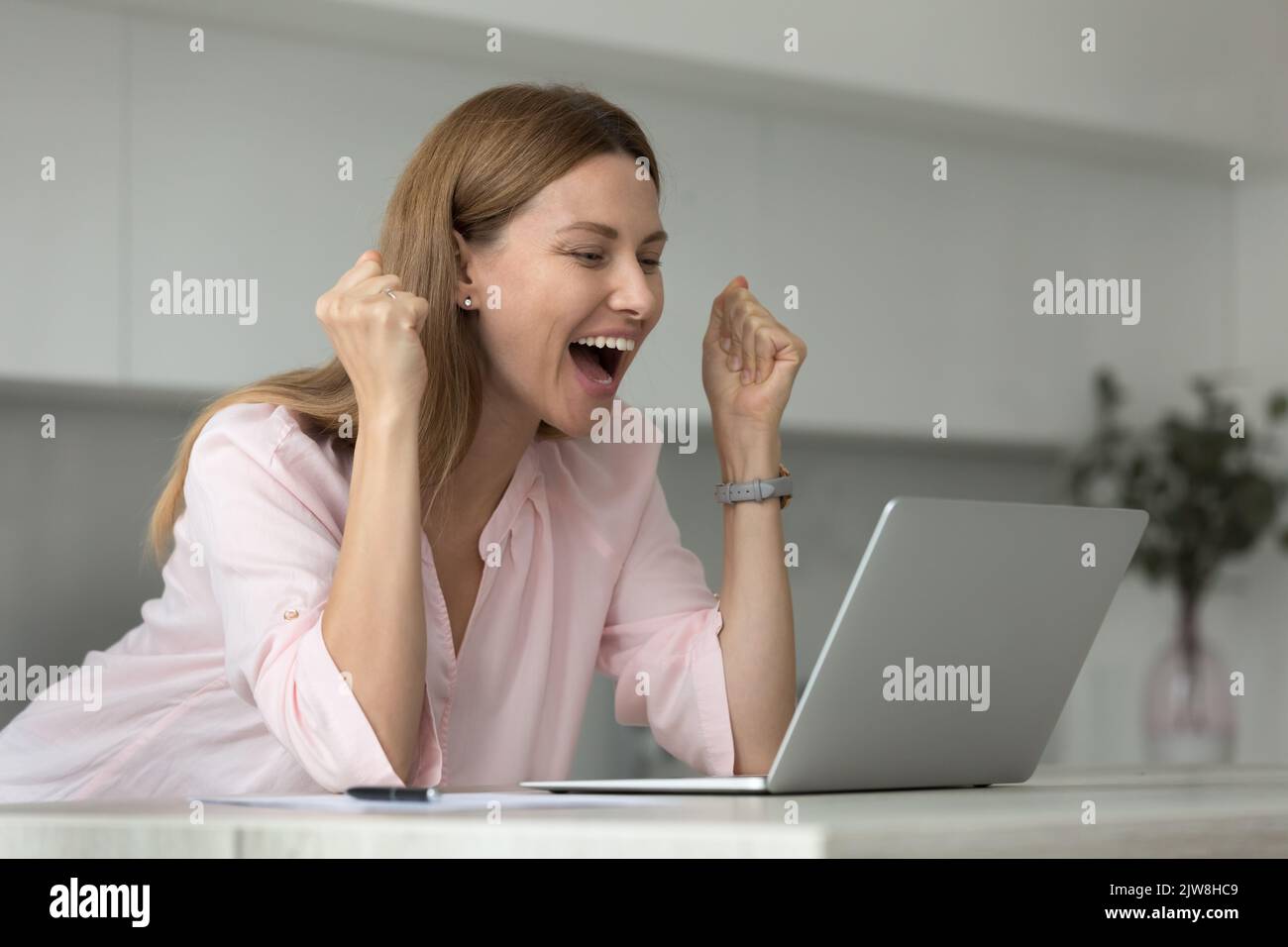 Happy laptop user woman celebrating good news, success Stock Photo - Alamy