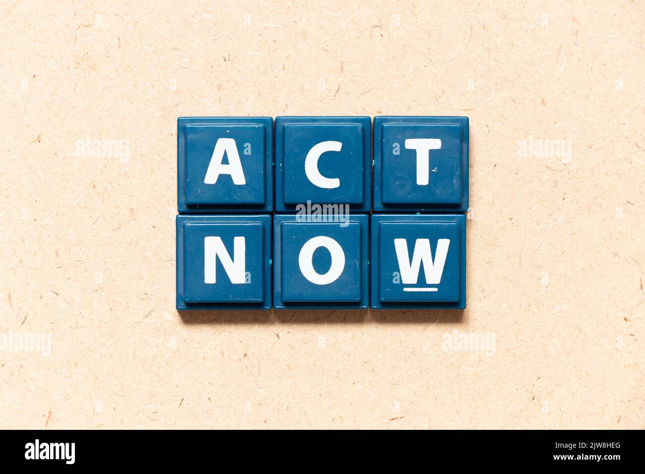 Tile letter in english word act now on wood background Stock Photo - Alamy