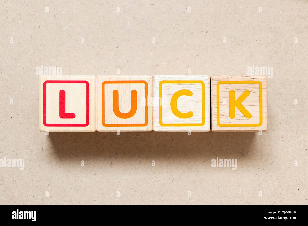 Color letter block in word luck on wood background Stock Photo - Alamy