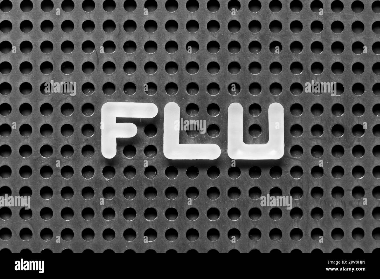 White alphabet letter in word flu on black pegboard background Stock ...