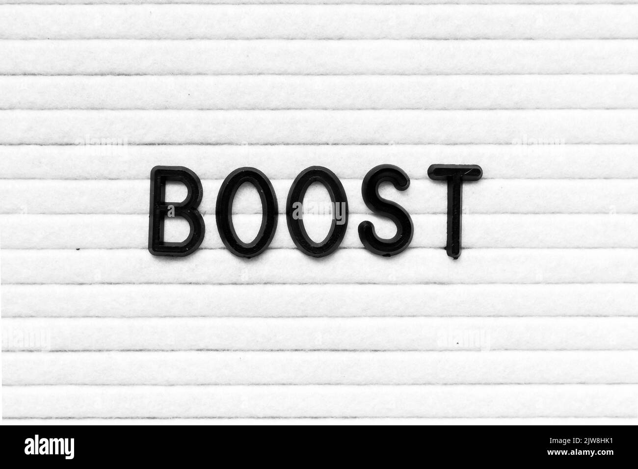 Black color letter in word boost on white felt board background Stock ...
