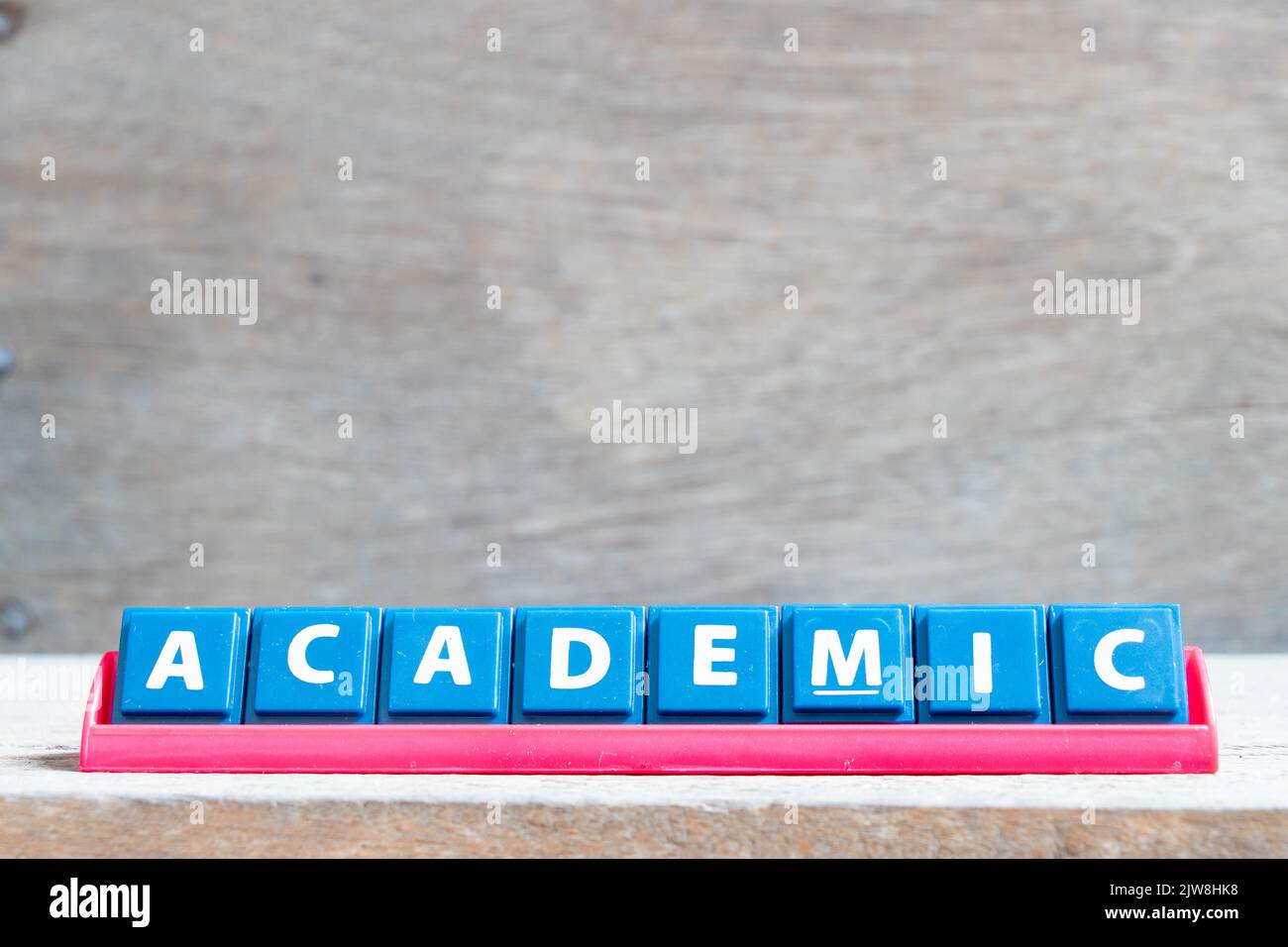 Tile alphabet letter with word academic in red color rack on wood ...