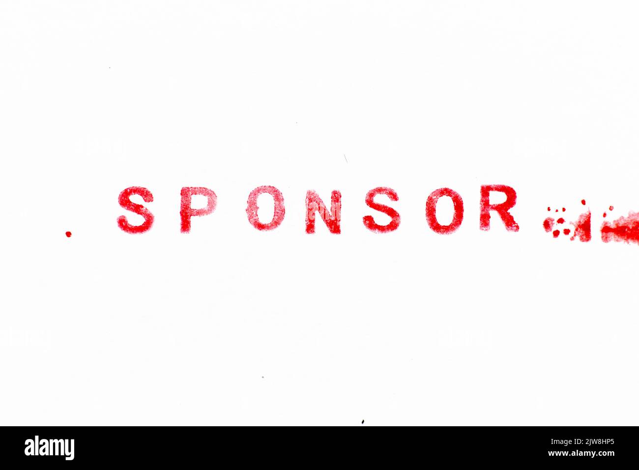 Red color ink rubber stamp in word sponsor on white paper background ...