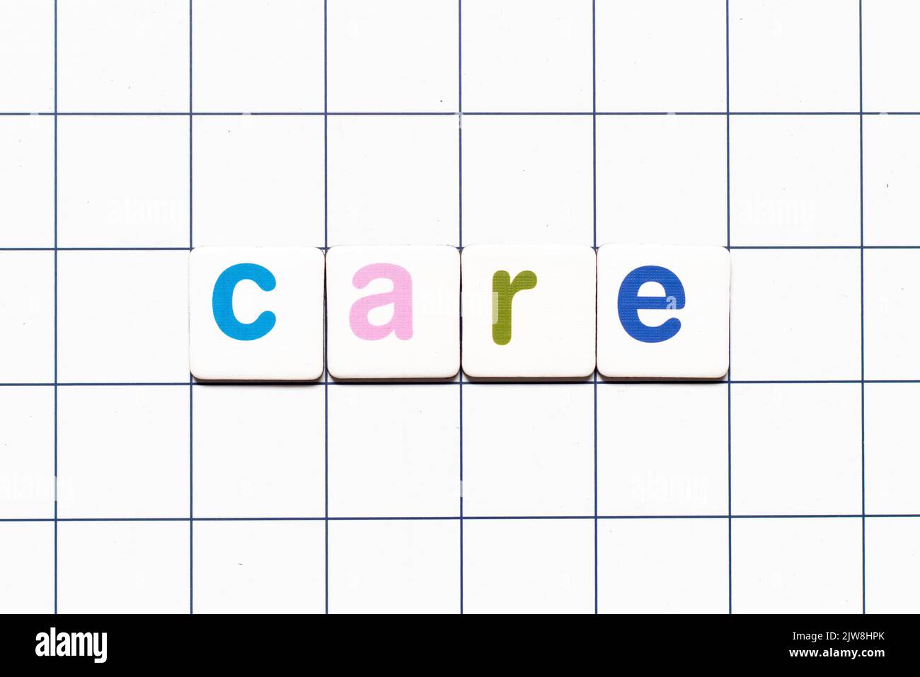 Colorful tile letter in word care on white grid background Stock Photo ...