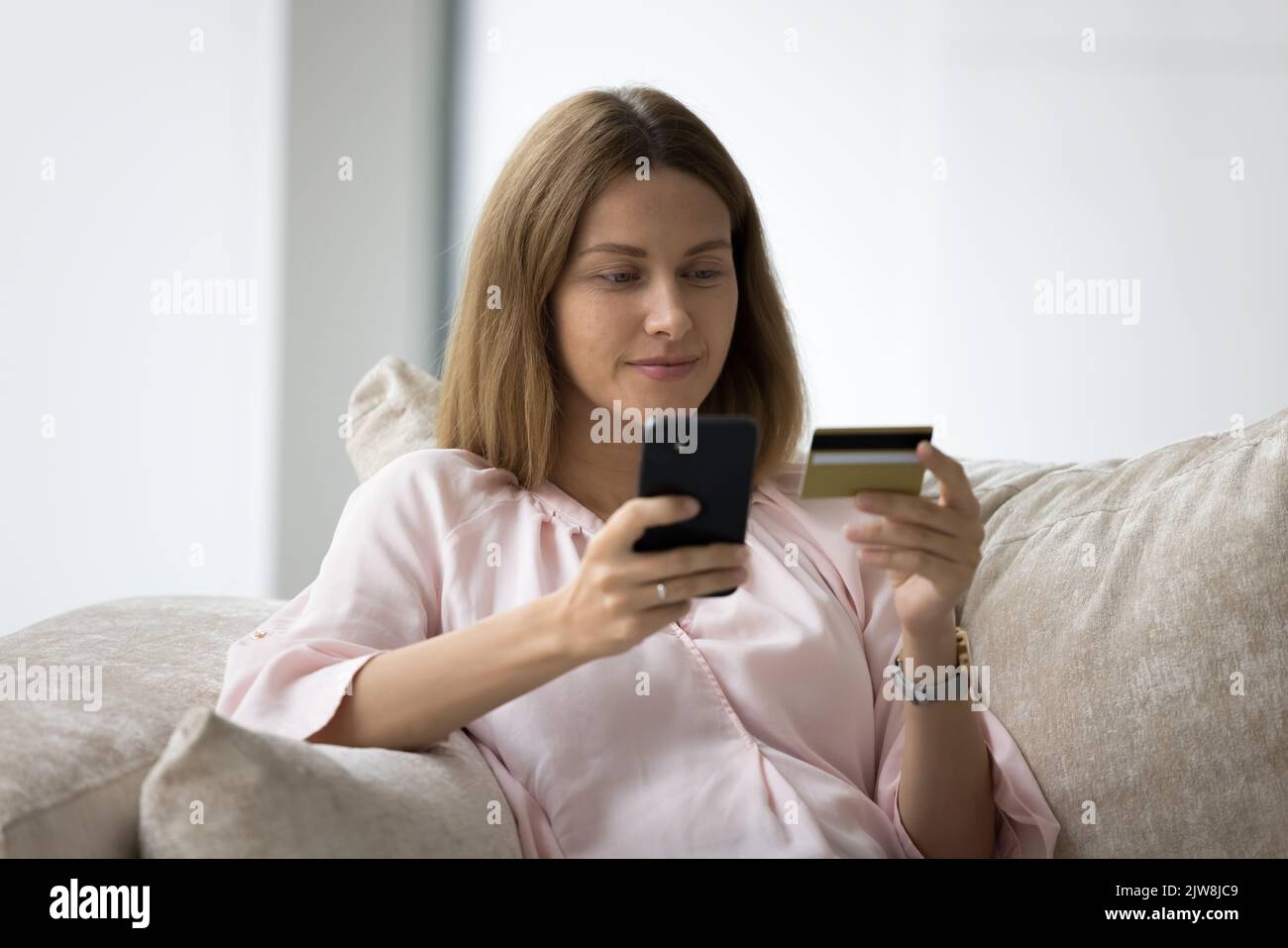 Millennial woman using ecommerce shopping app on mobile phone Stock ...