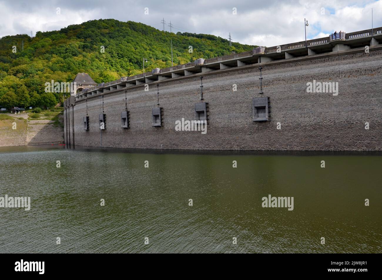Dam at Edersee at low tide, with green mountains in the background ...
