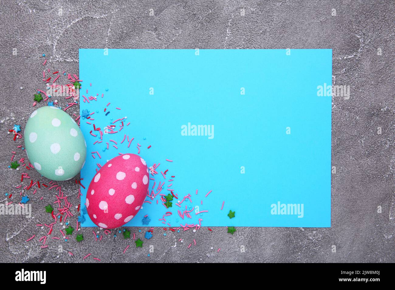 Colorful easter eggs on a grey background, flat lay Stock Photo - Alamy