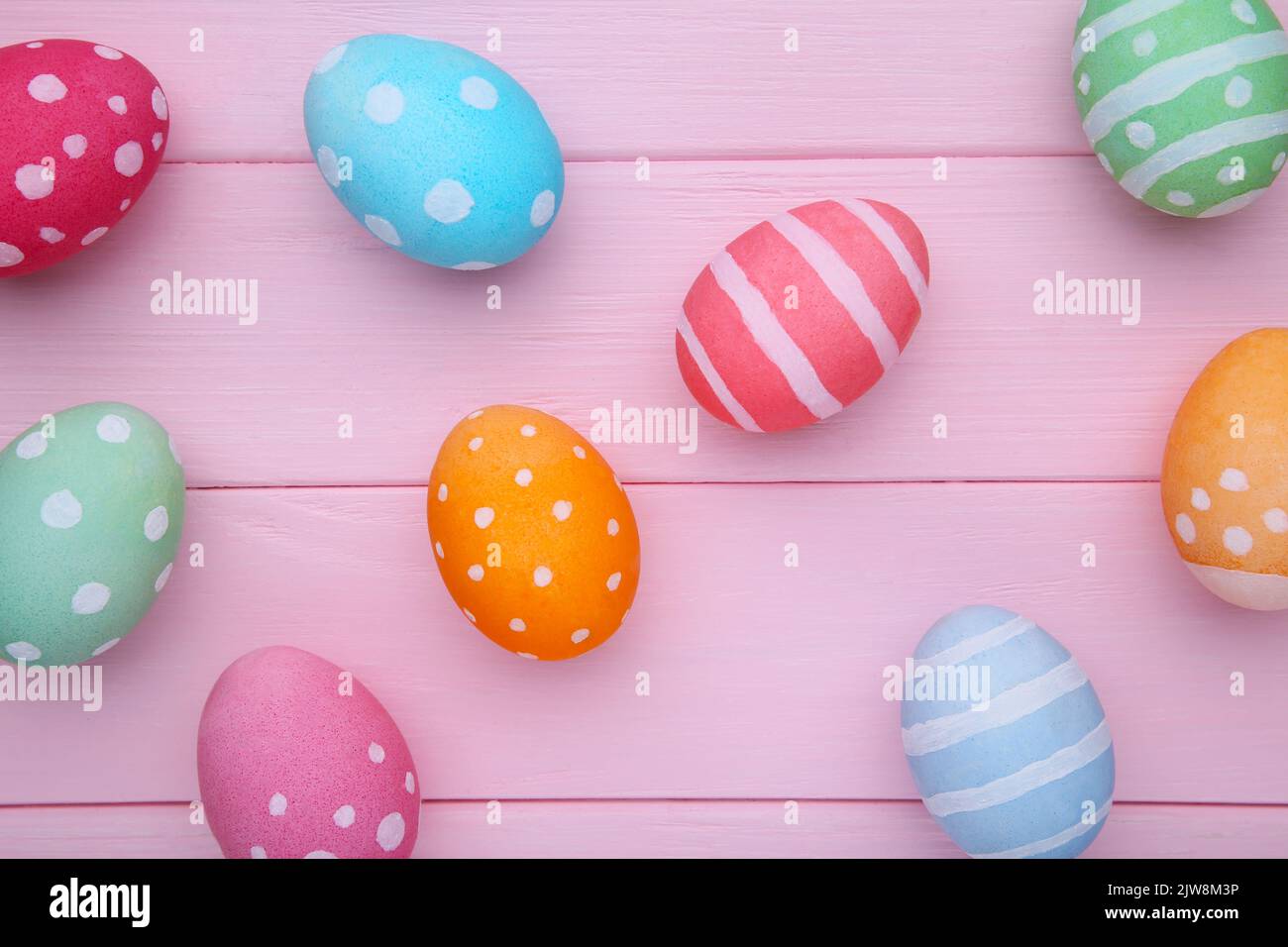 Colorful easter eggs on a pink background Stock Photo - Alamy