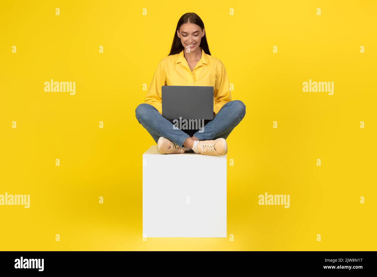 Lady Working On Laptop Computer Smiling Sitting Over Yellow Background ...