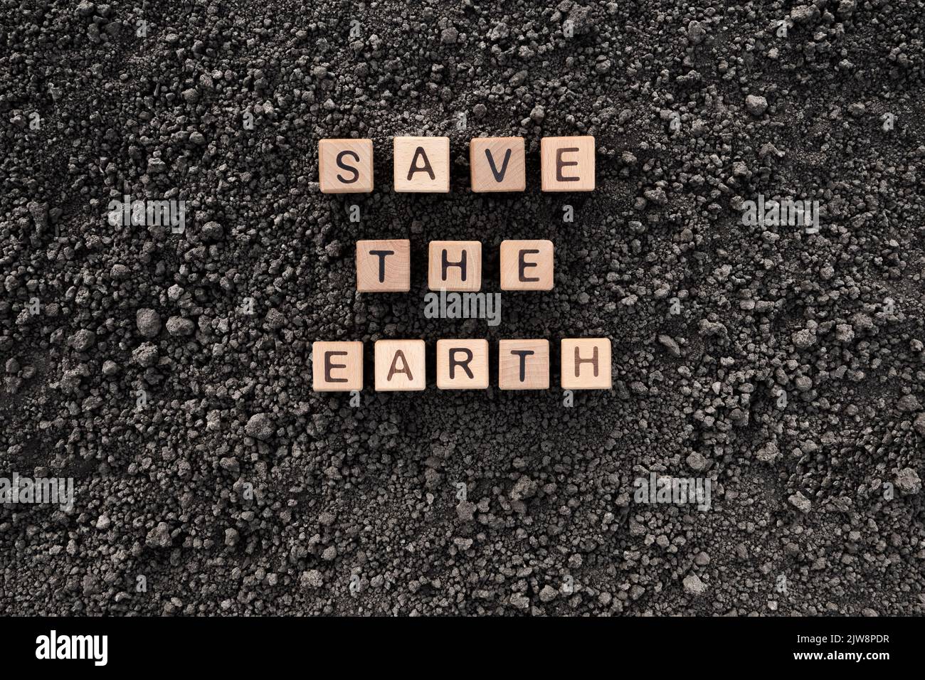 Black soil background earth day. Letter block toy cube wood text Save ...