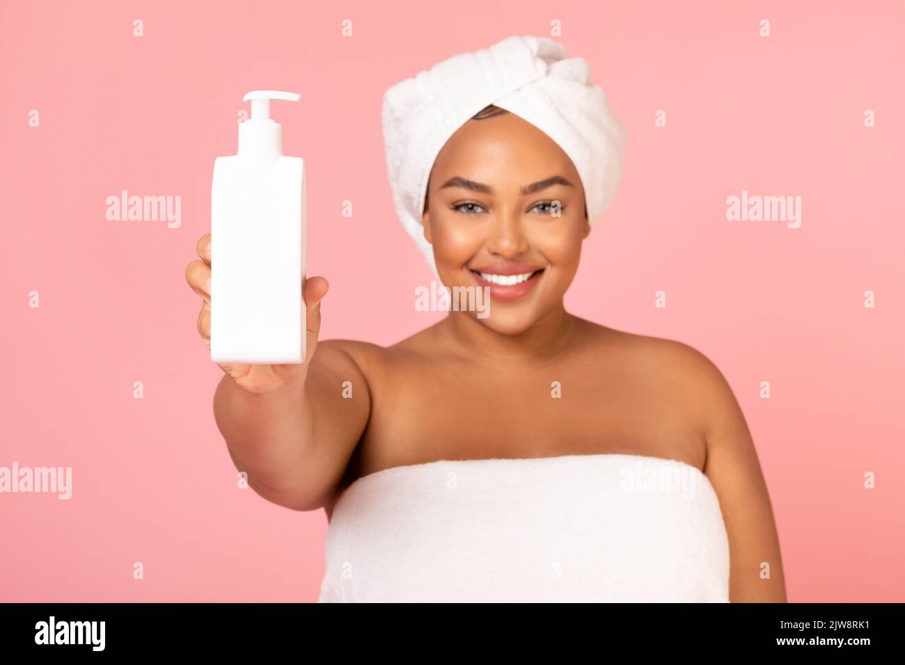Black Woman Showing Dispenser Bottle Advertising Cosmetic Product, Pink ...