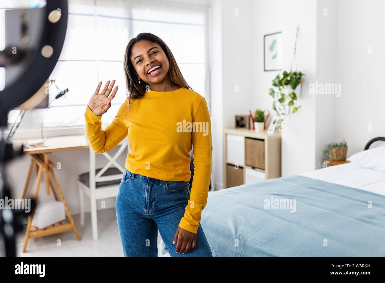 Happy young latin millennial or gen z woman streaming using mobile ...