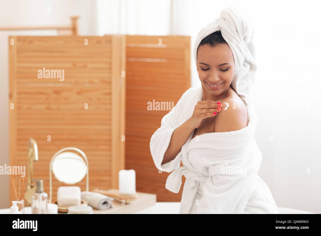 Lady Applying Body Lotion On Shoulders Moisturizing Skin In Bathroom ...
