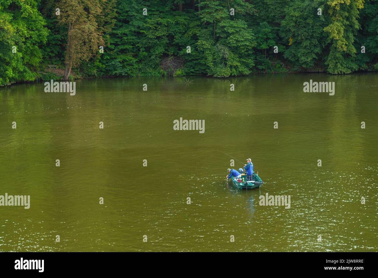Fishermen in a boat catch fish on the dam Stock Photo - Alamy