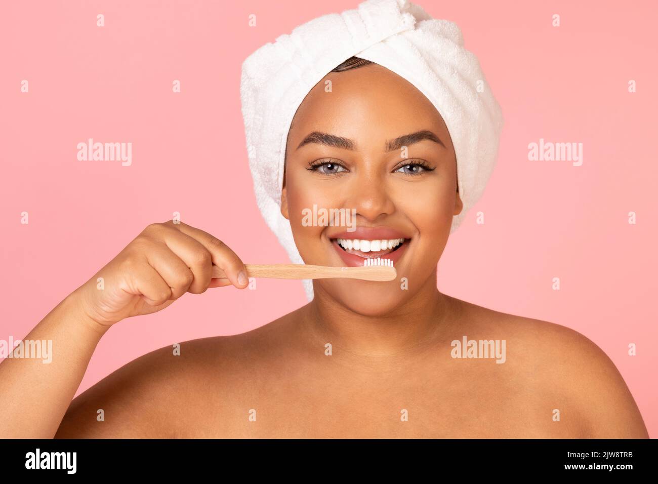 Portrait Of African American Lady Brushing Teeth Over Pink Background ...