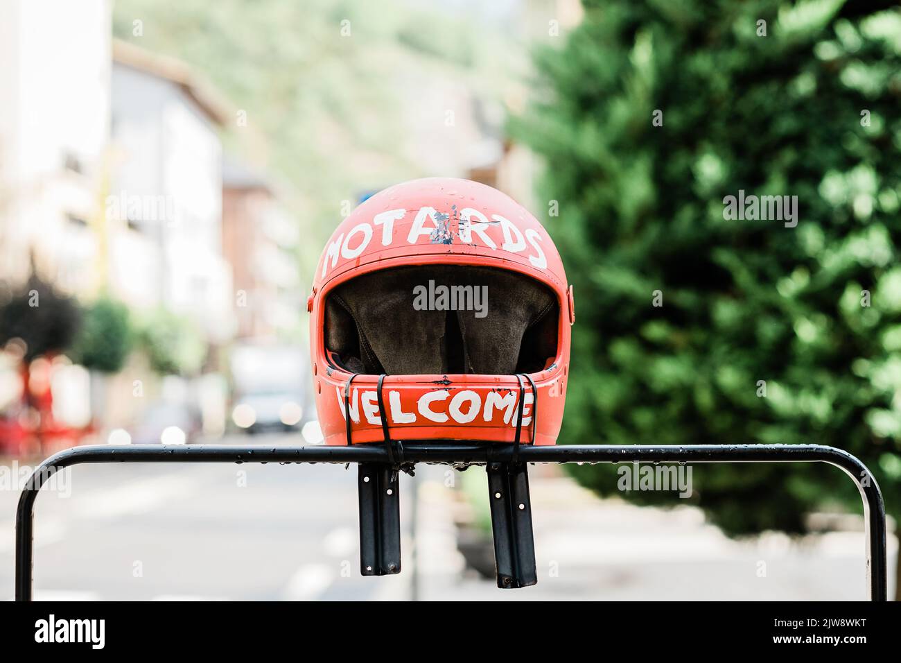 red motorcycle helmet. Motards welcome concept Stock Photo - Alamy