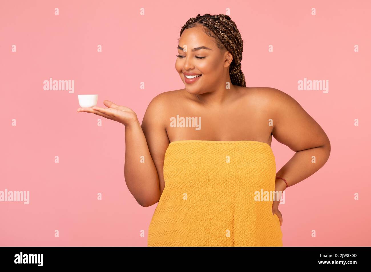 Pretty Obese Black Woman Holding Moisturizer Jar Over Pink Background ...