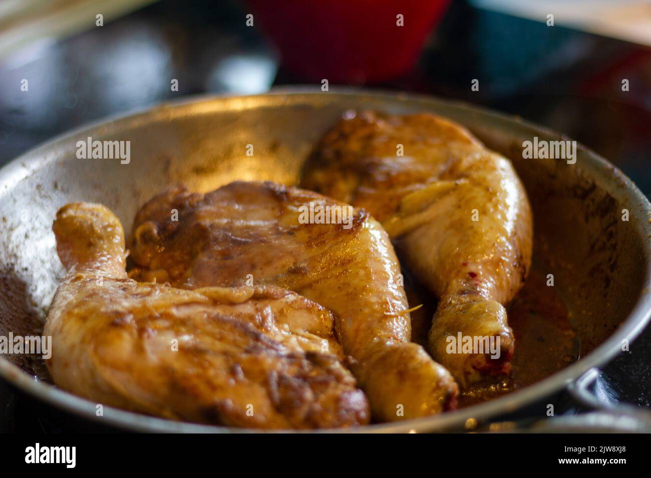 The high-angle view of chicken legs frying in a steel pan Stock Photo ...