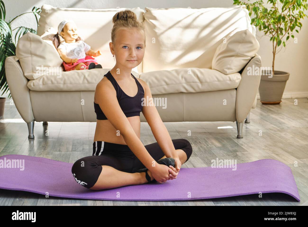 Kid repeating exercises while watching online yoga gymnastics session ...