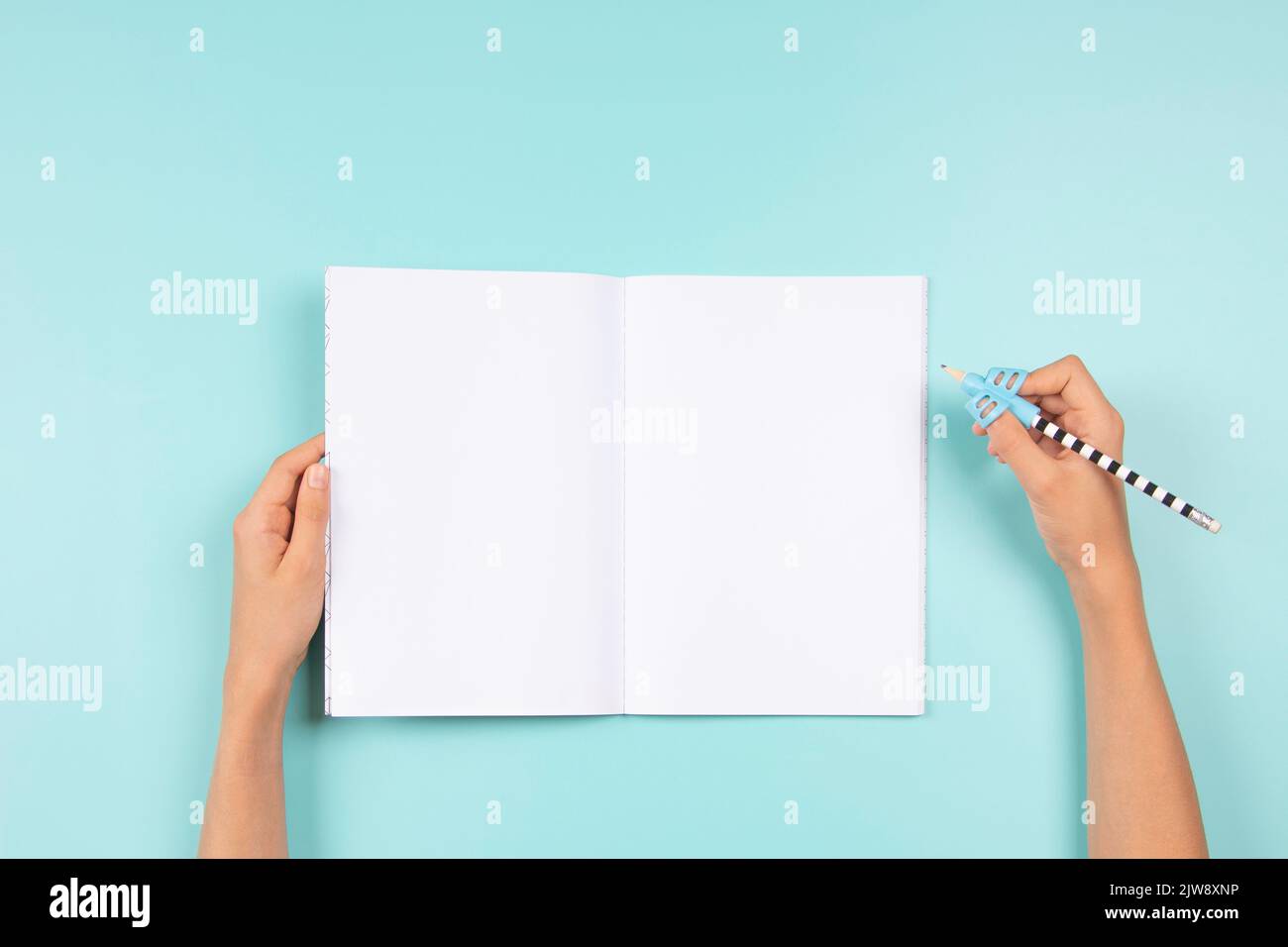 Kid hands using pencil with silicone three finger pen holder. Hand ...