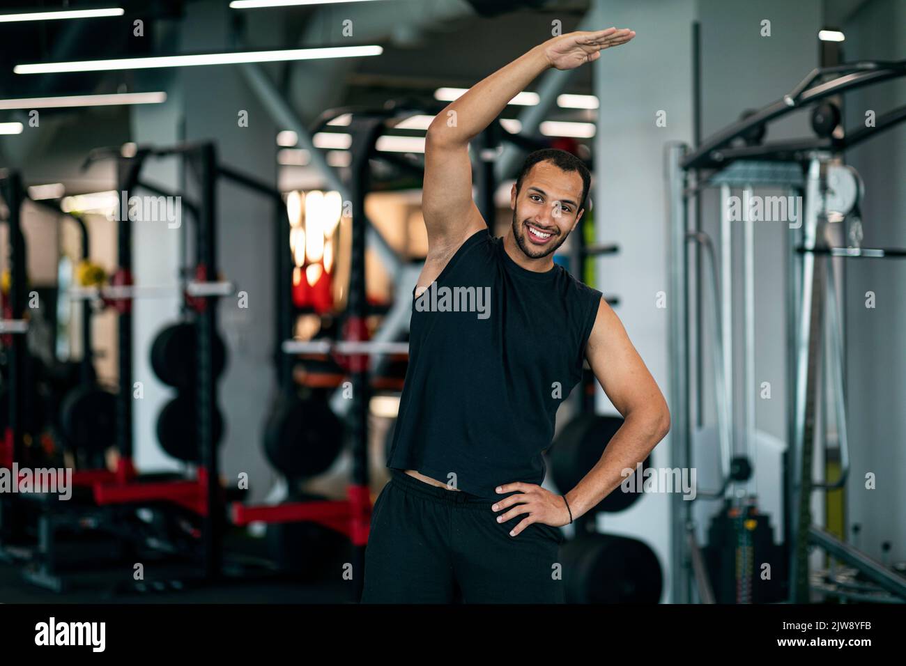 Athletic Young African American Man Stretching To Sides While Training ...