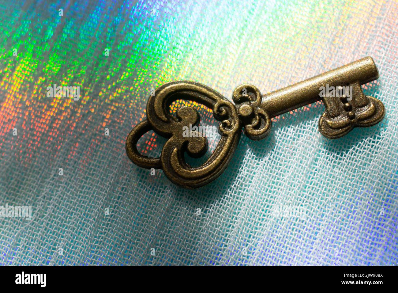 Vintage key. .Antique key. Retro key on colorful fabric background ...