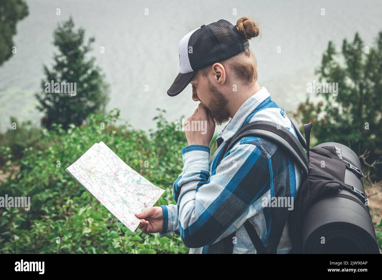 Male traveler looking at the map, hiking concept Stock Photo - Alamy