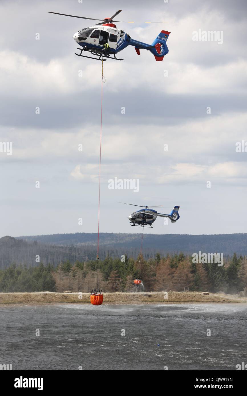Schierke, Germany. 04th Sep, 2022. A firefighting helicopter fetches ...