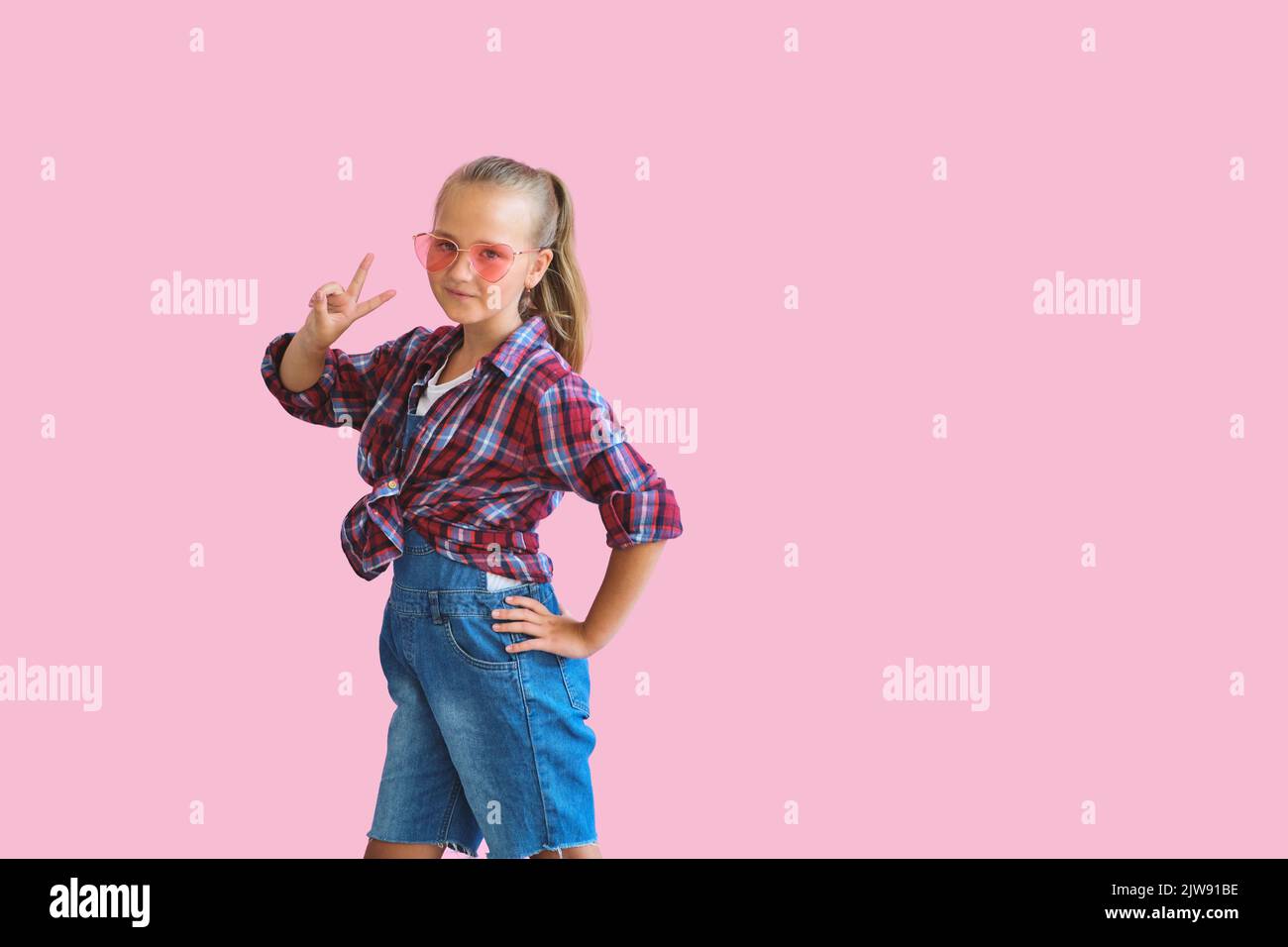 cool kid girl in pink sunglasses posing against pink background Stock ...