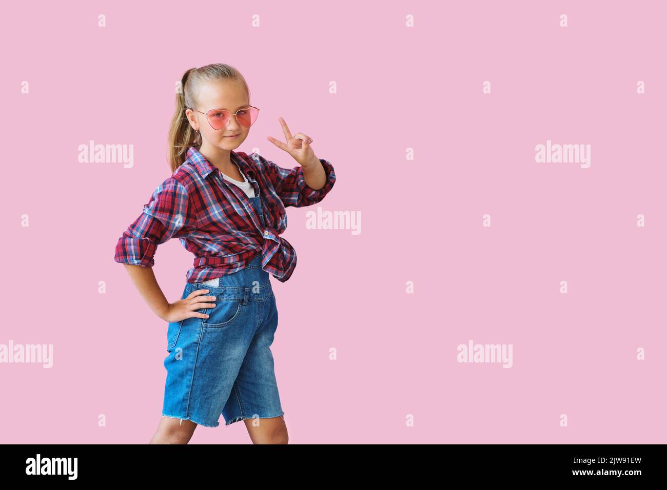 cool kid girl in pink sunglasses posing against pink background Stock ...