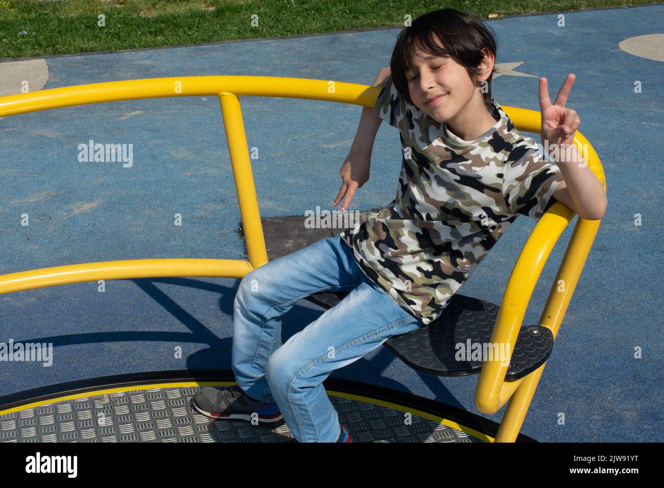 Portrait of little boy showing victory hand sign Stock Photo - Alamy