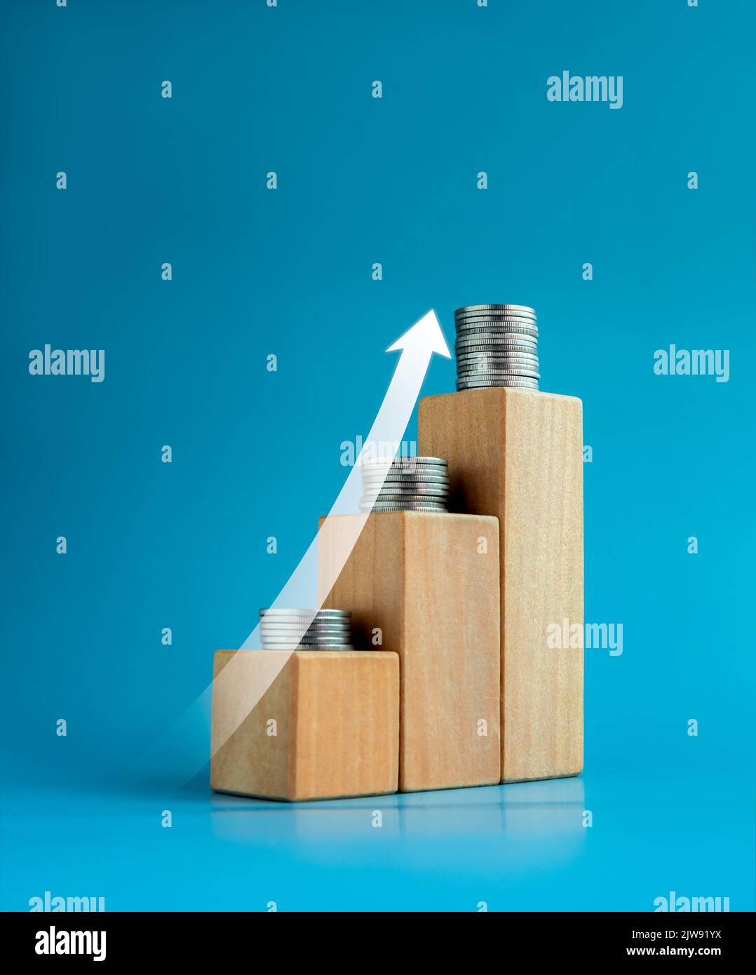 Shining rise up arrow on wooden cube blocks with coin stacked, bar ...