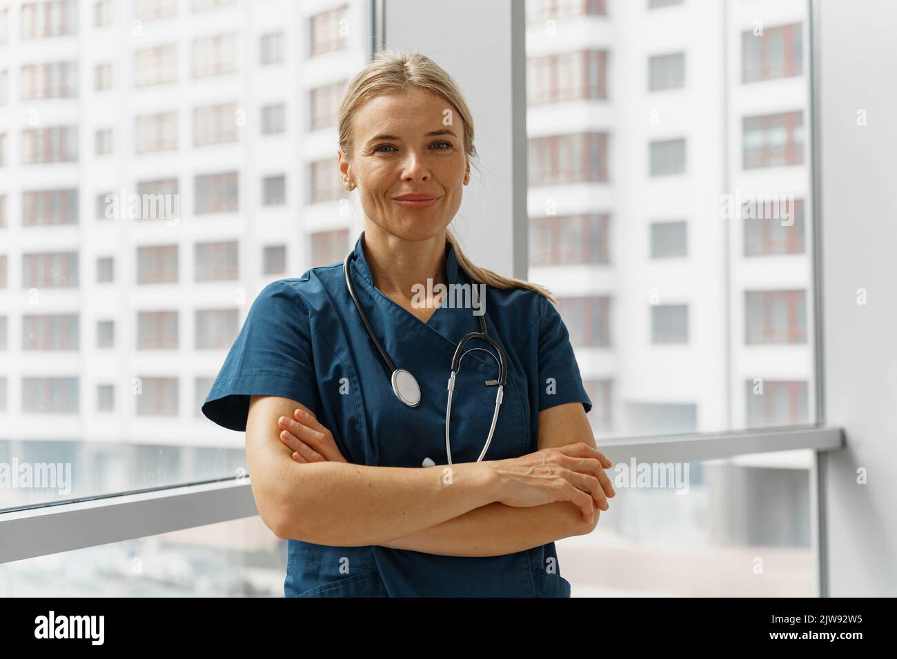 Portrait of professional doctor therapist standing near window in ...