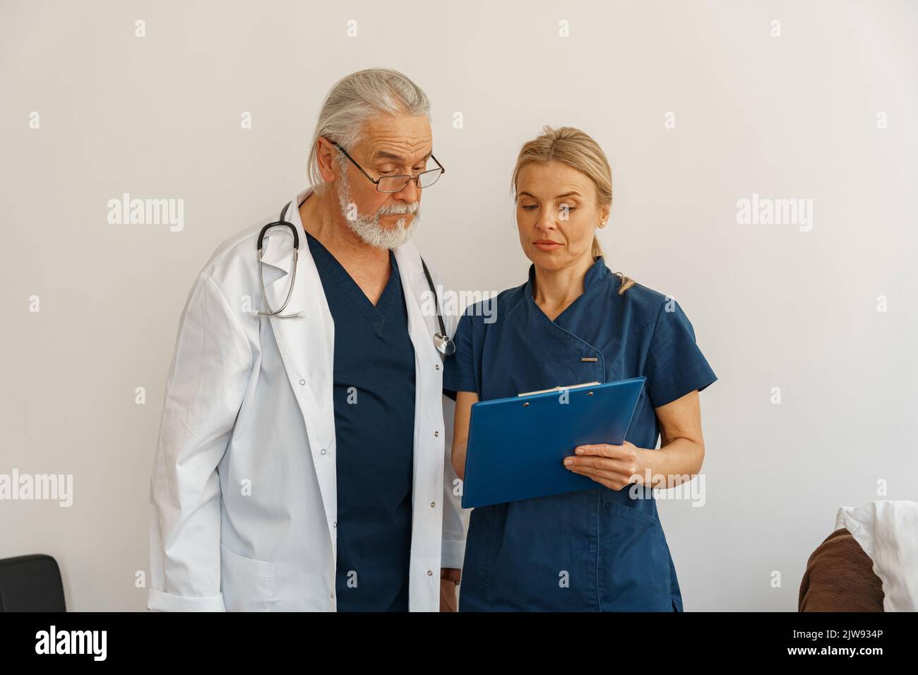 Two doctor colleagues discussing patient diagnosis stand in medicine ...