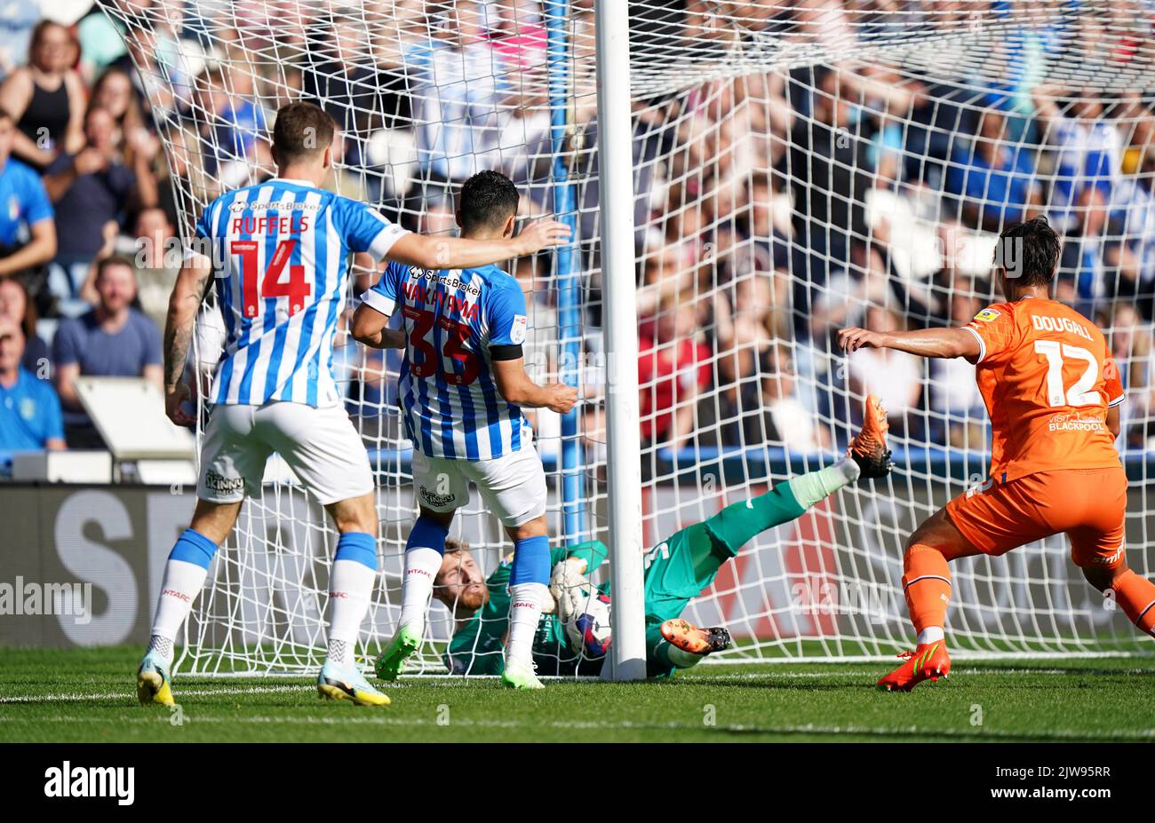 Blackpool goalkeeper Daniel Grimshaw makes a double save to deny ...