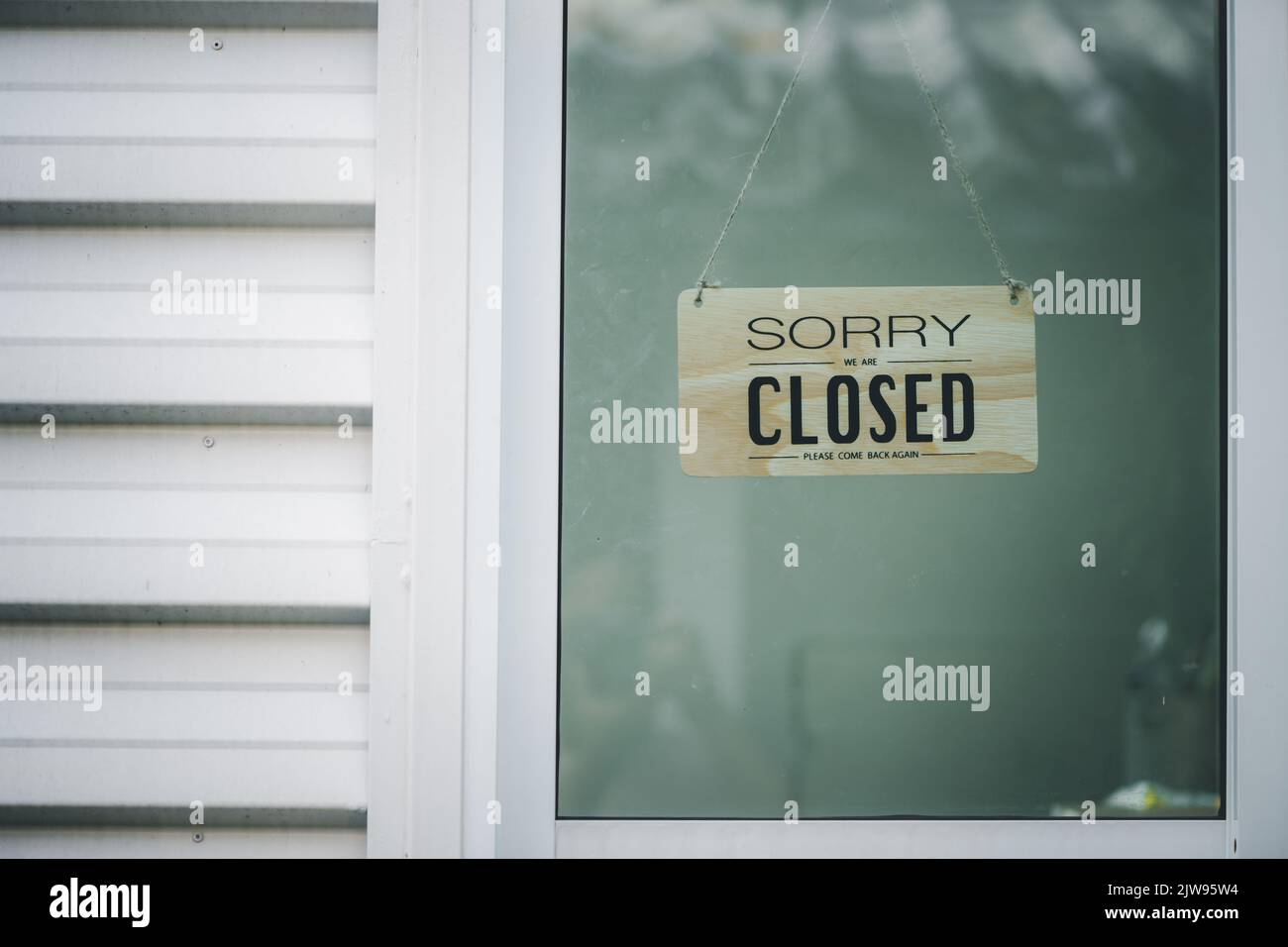 Sorry we're closed sign. grunge image hanging on a glass door Stock ...