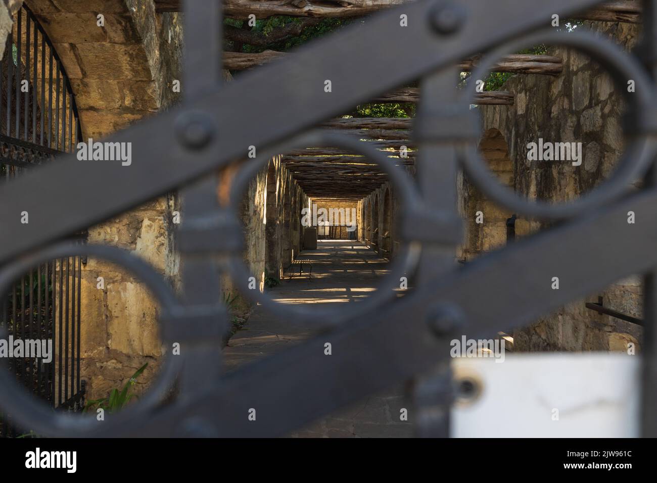 The Alamo side barracks looking through an iron gate Stock Photo - Alamy