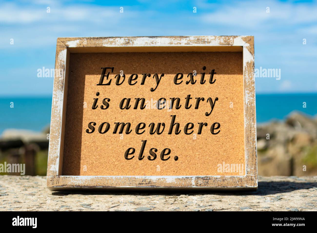 Motivational quote on wooden frame with blurred background of ocean ...
