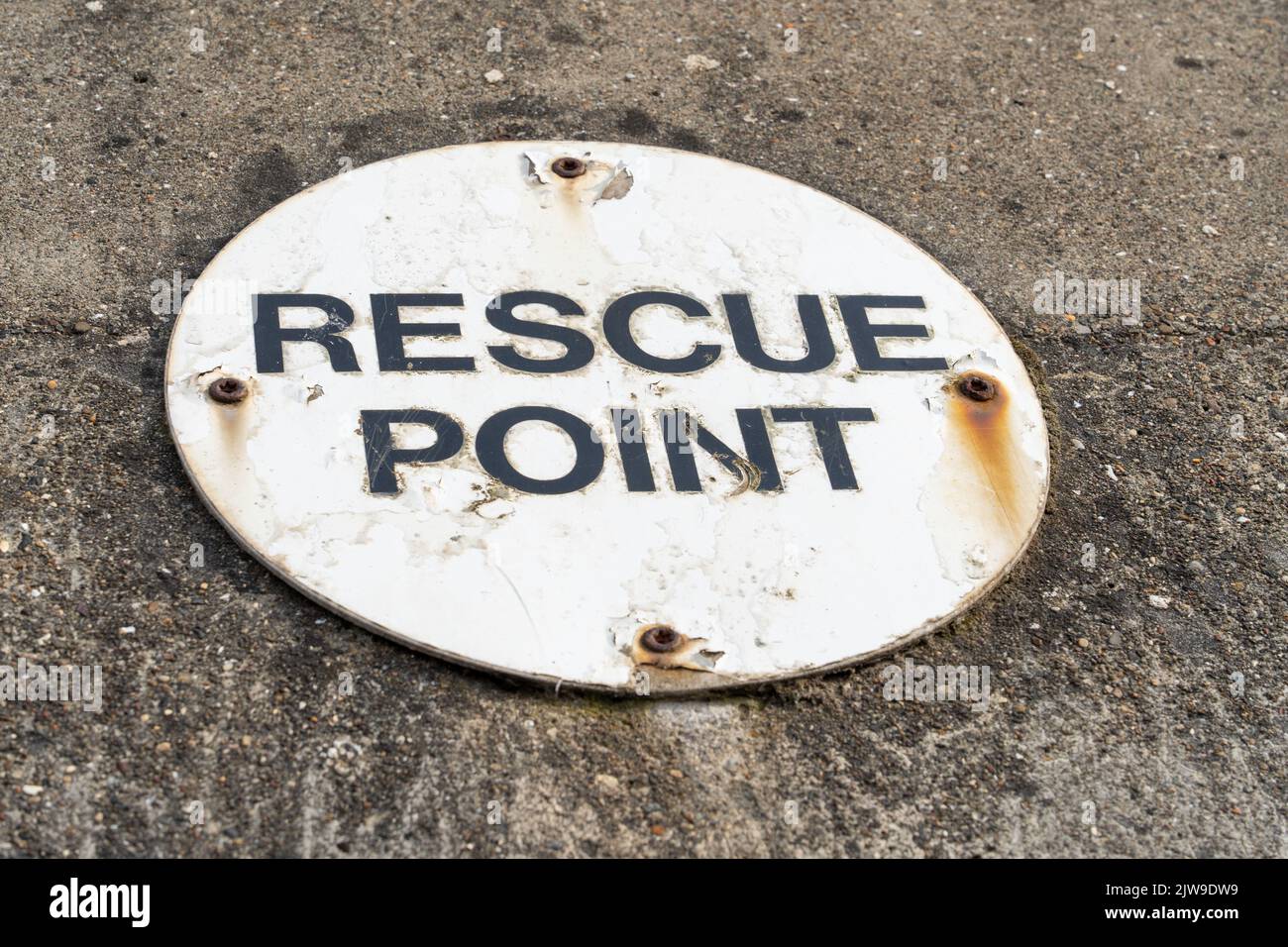 Rescue point sign attached to a sea wall in a coastal town in the UK ...